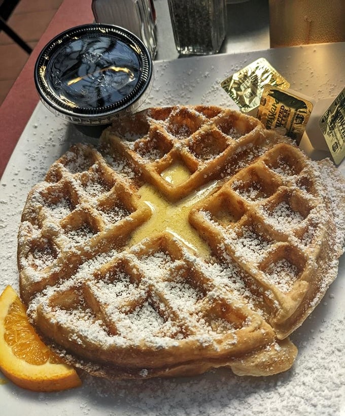 This Belgian waffle doesn't need a passport—its golden squares creating perfect pools for maple syrup to skinny-dip.