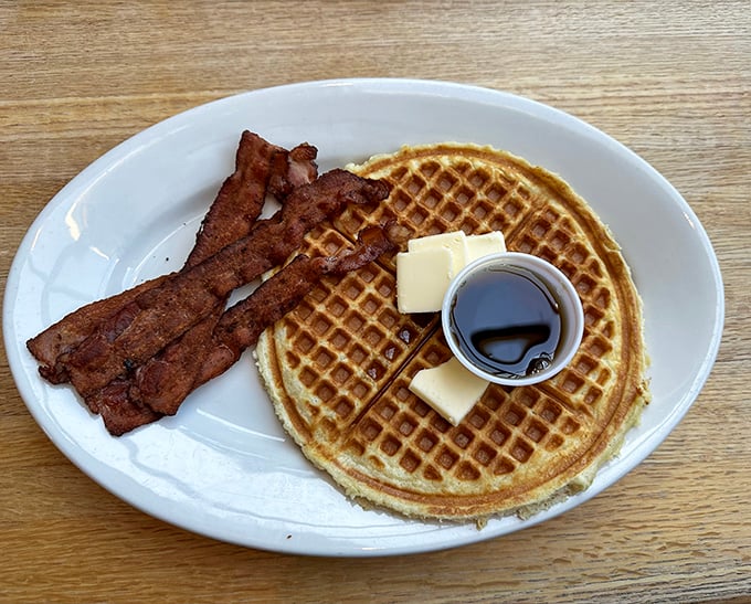 The waffle grid: nature's perfect syrup-retention system, accompanied by bacon that means serious business.