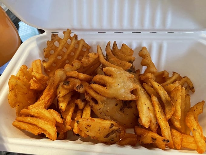 These aren't just waffle fries – they're crispy, seasoned potato architecture. The perfect supporting actor to the chicken's starring role.