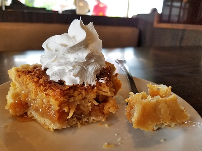 Not just dessert, but a slice of Americana—homemade walnut pie topped with a cloud of whipped cream that defies gravity.