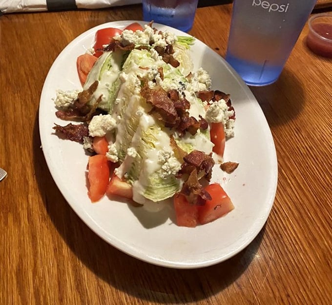 The wedge salad—that glorious throwback that never goes out of style. With bacon crumbles and blue cheese, it's the salad for people who don't "do" salads.