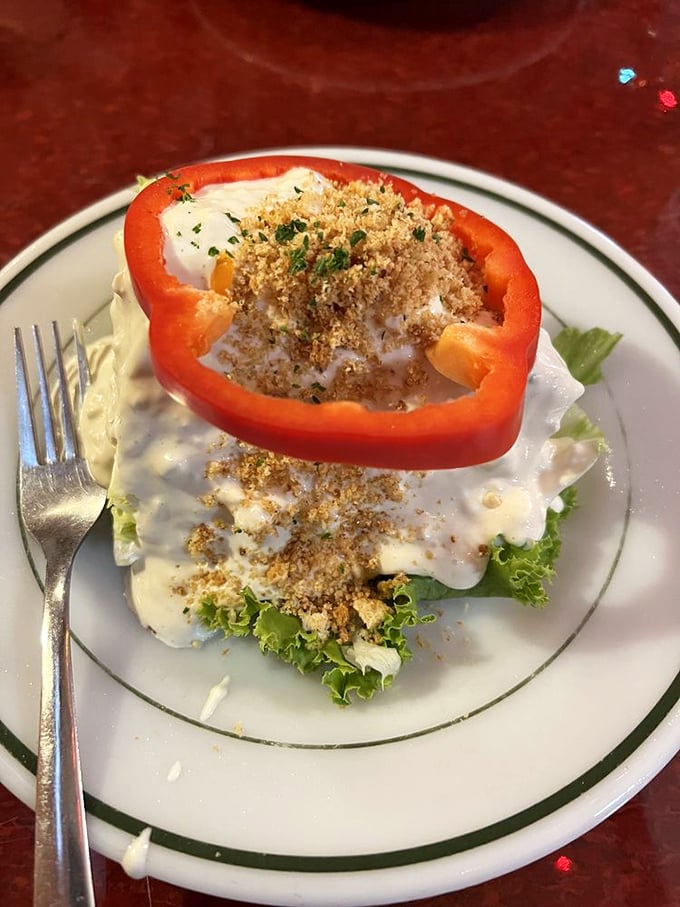 The wedge salad at Bonge's proves that sometimes the classics need no improvement—just a red pepper ring, creamy dressing, and enough crumbled topping to make vegetables exciting.