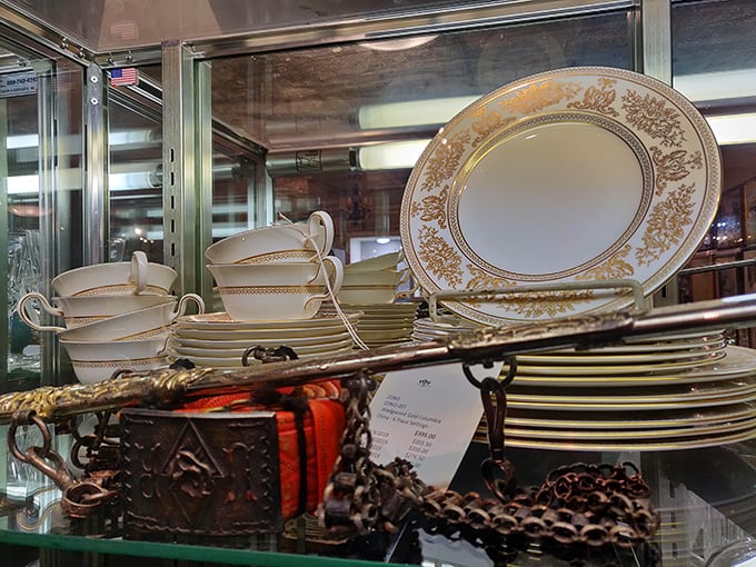 Fine china stacked with precision—each plate a canvas of gold and cream that makes your everyday dinnerware look like it's trying too hard.