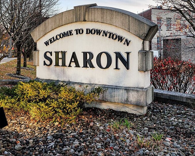 The "Welcome to Downtown Sharon" sign doesn't need neon or flash—its classic stone construction speaks to the city's understated charm.