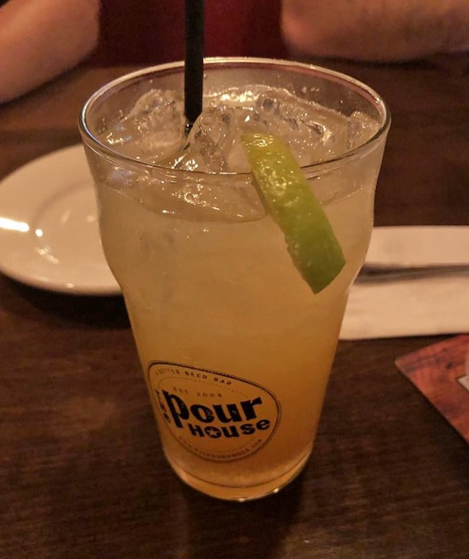 Their signature cocktail gleams like liquid sunshine, with a lime wedge perched on the rim—the perfect companion for those briny oysters waiting at your table.