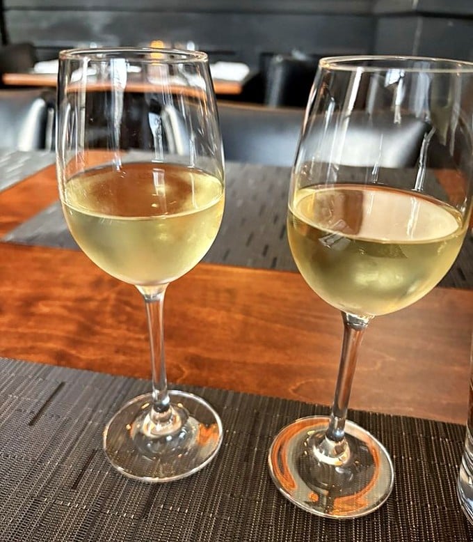 Two glasses of liquid sunshine waiting to complement whatever masterpiece arrives from the kitchen. Wine o'clock is the best time.