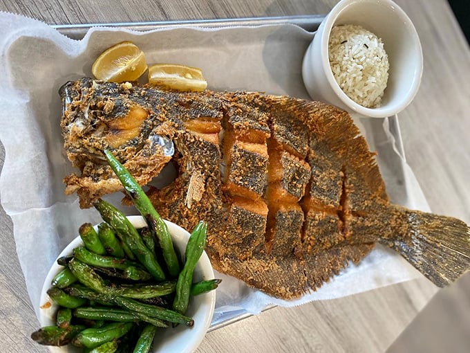 This whole fried flounder looks like it's still swimming – right through a sea of delicious seasoning and perfect crispiness.