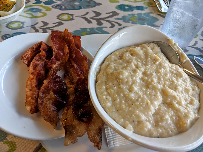 Bacon strips and creamy grits – proof that sometimes the simplest pleasures are the most profound ones.
