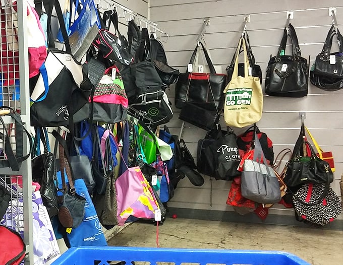 A hanging garden of handbags—from practical totes to night-on-the-town clutches—each waiting for the right shoulder to come along.