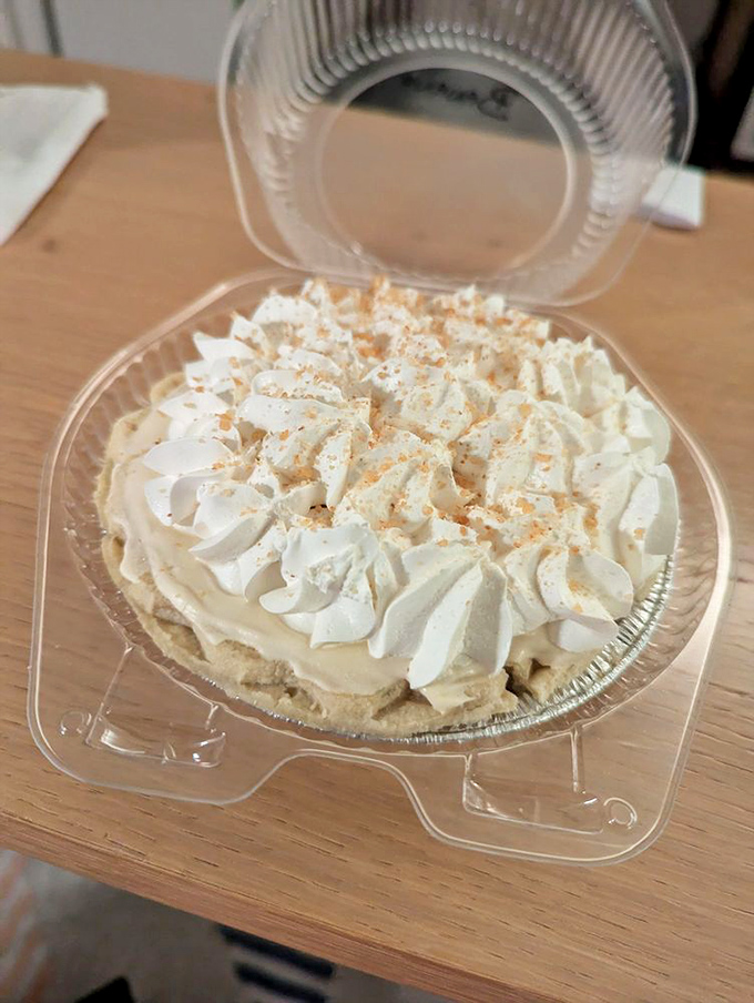 Cream piled high like clouds on a summer day. This banana cream pie isn't just dessert—it's a mood-altering experience with a crust.