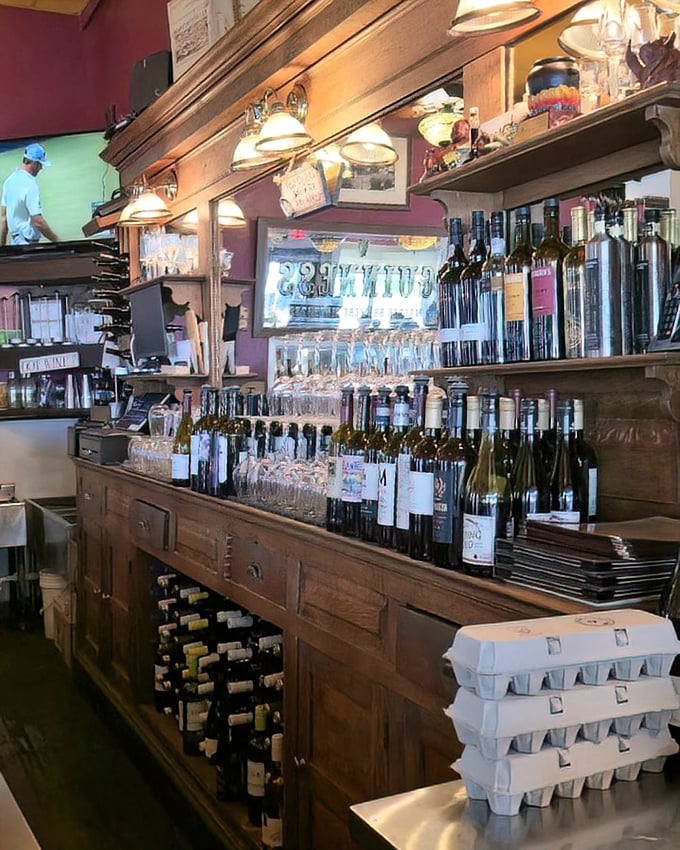 The bar isn't just stocked—it's curated, with bottles standing at attention like soldiers guarding the gateway to a good time.