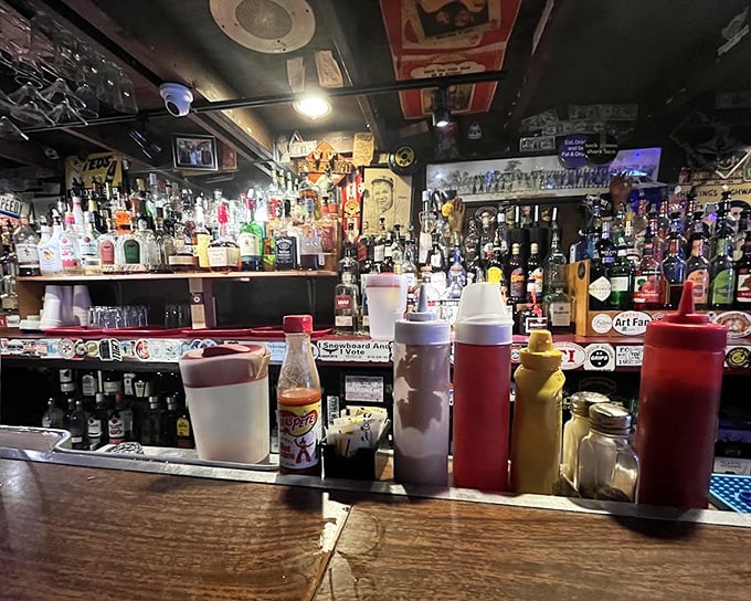 The bar – where spirits flow and stories grow. Those condiment bottles stand ready for whatever burger emergency might arise.
