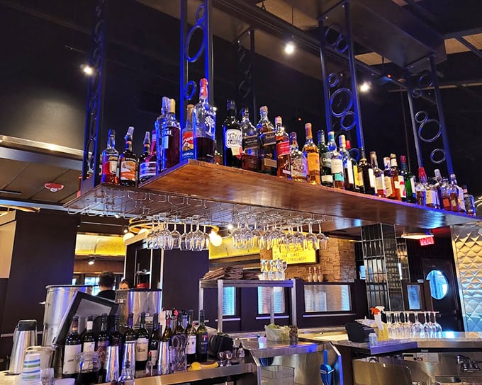 The bar doesn't just serve drinks—it showcases them, with bottles displayed like trophies and glasses hanging like crystal stalactites ready for your celebration.