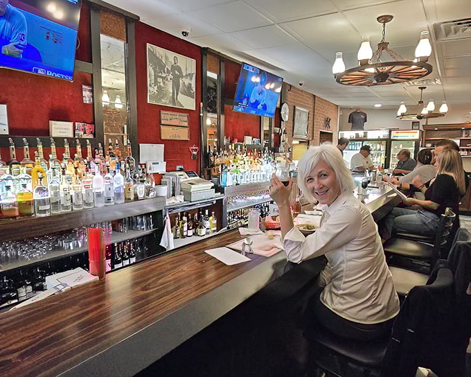 The bar area—where stories flow as freely as the wine. That smile says she's found her happy place in Philadelphia's Italian heart.