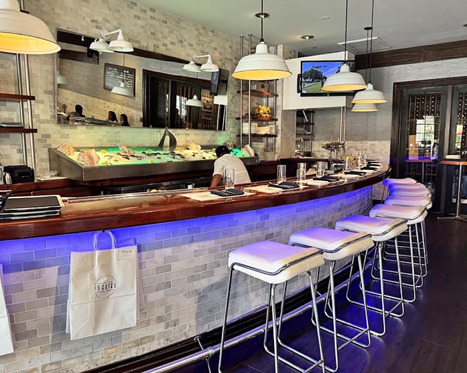 The raw bar—where seafood aficionados gather like pilgrims at a shrine. That blue lighting isn't just ambiance; it's setting the mood for a serious relationship with shellfish.