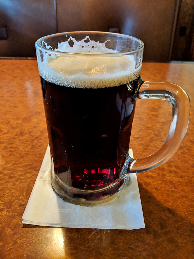 A proper dark beer served in a mug substantial enough to double as a bicep workout between sips.