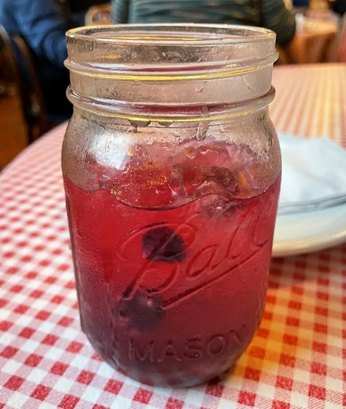 That ruby-red drink in a Mason jar isn't just refreshing—it's a liquid reminder that sometimes the simplest pleasures deserve the prettiest presentation.