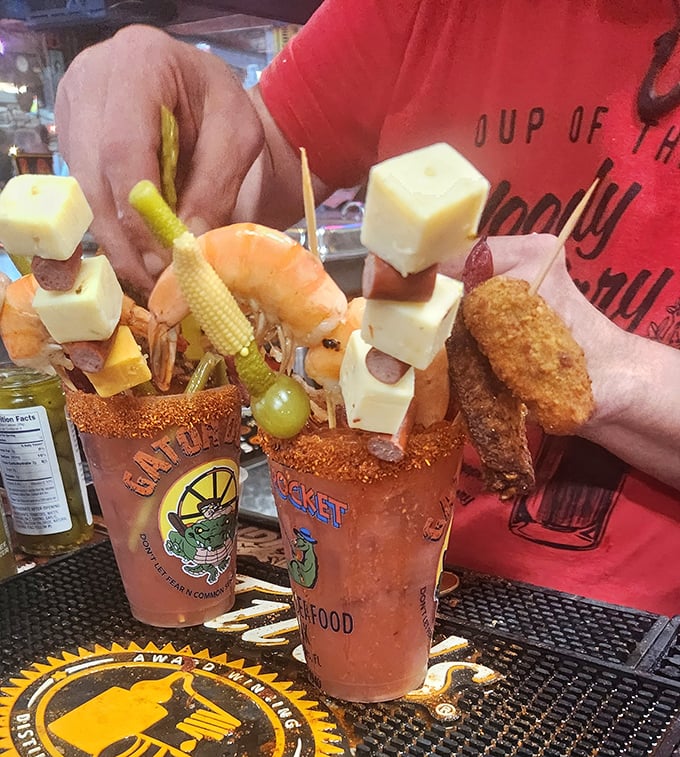 These loaded Bloody Marys aren't just drinks, they're architectural achievements—skyscrapers of garnish that require a building permit and an appetite.