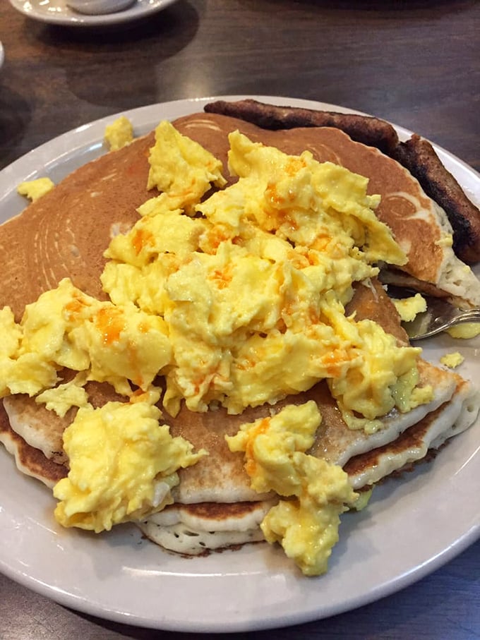 Pancakes crowned with scrambled eggs—a breakfast tower of power that laughs in the face of "just having a light breakfast" nonsense.