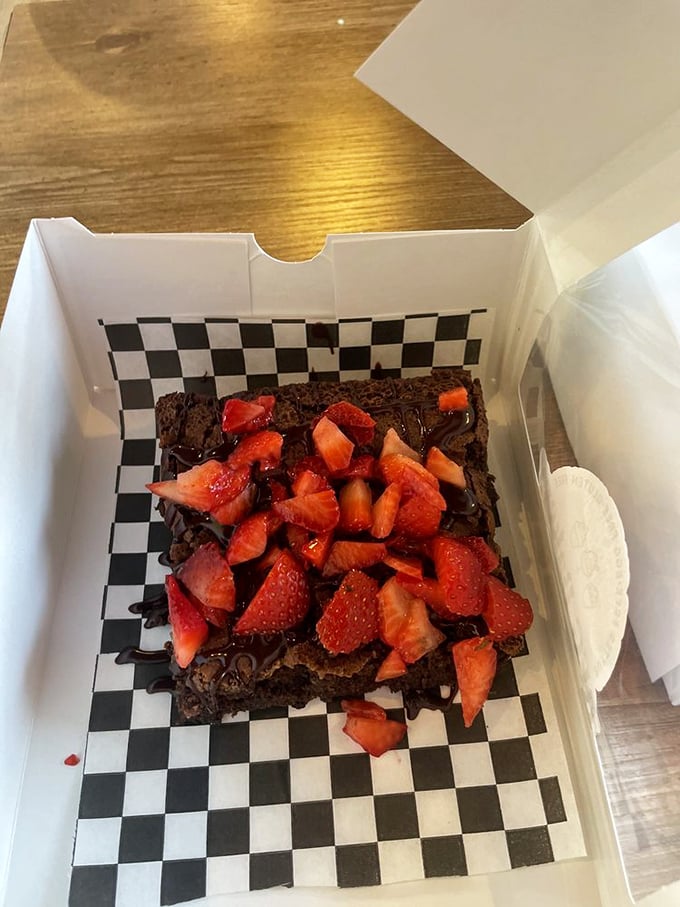 A brownie that doesn't just have strawberries on top—it's wearing them like a crown. Chocolate royalty deserves nothing less.