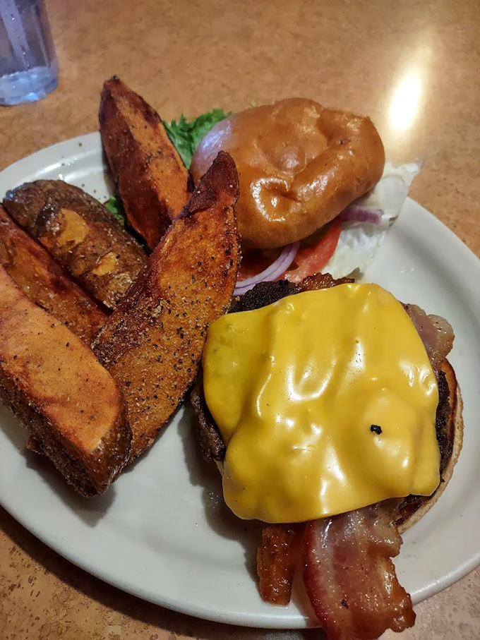 A burger that doesn't need fancy aioli or artisanal buns to impress, just honest beef and melty cheese, with potato wedges that could start their own fan club.