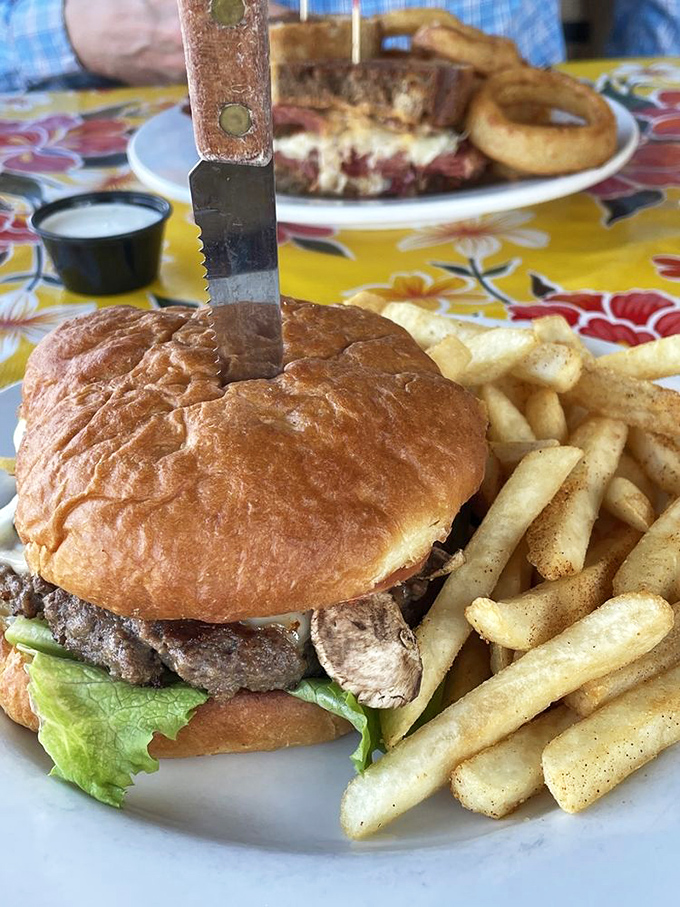 A burger that requires both hands and a strategy – the kind that makes you wonder why we ever invented fancy food in the first place.