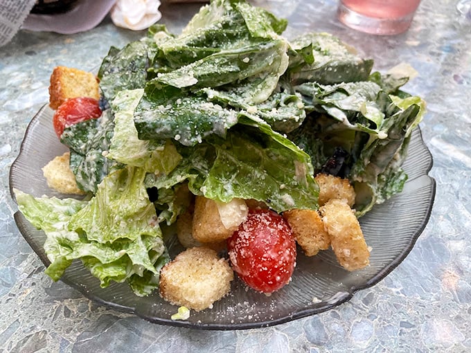Caesar salad gets the royal treatment with fresh romaine, shaved parmesan, and croutons that crunch like they mean business.