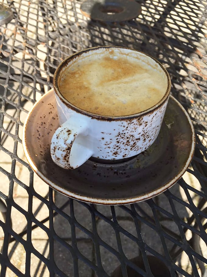 This isn't just coffee – it's a tiny ceramic pool of possibility, sitting pretty on that patio table, promising to transform you from zombie to functioning human.