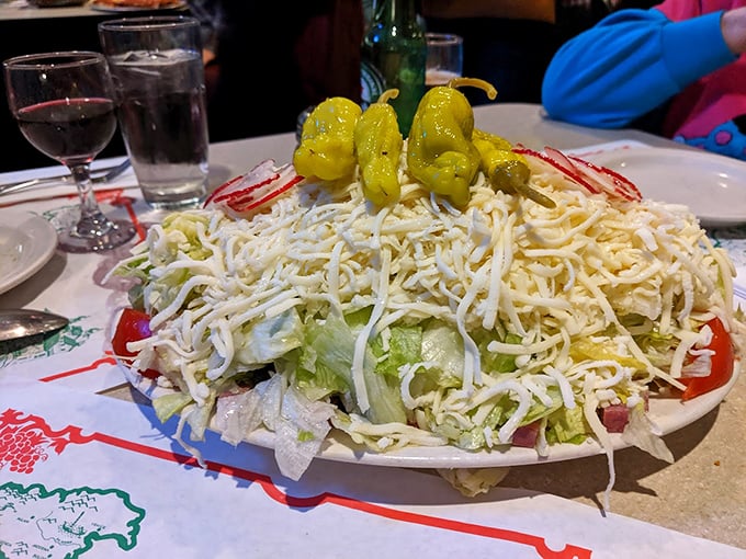 The salad that launched a thousand cravings—a mountain of cheese atop crisp lettuce with those signature banana peppers standing guard like yellow sentinels.