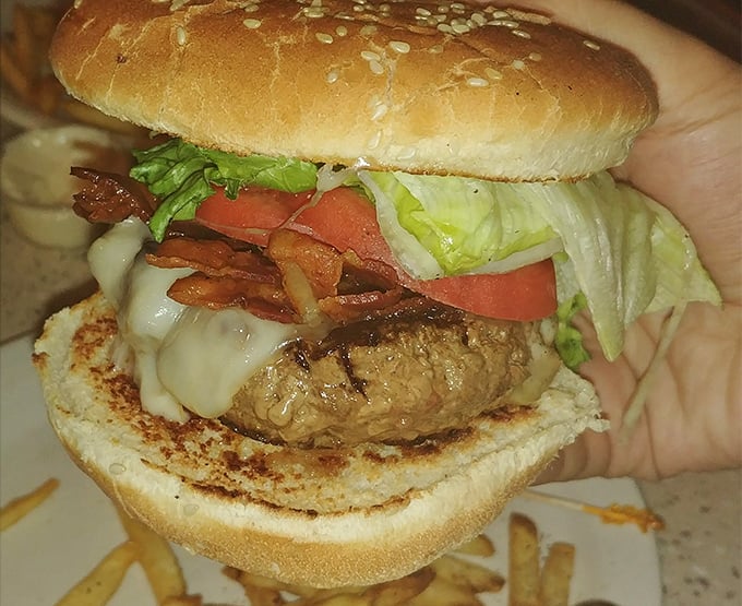 This isn't just a burger—it's a hand-held masterpiece of melted cheese, crispy bacon, and fresh veggies that demands to be photographed before the first bite.