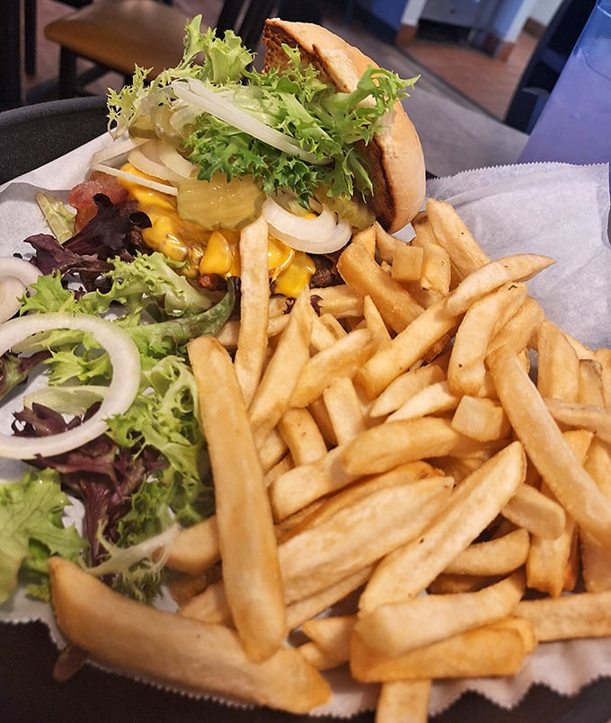 This burger doesn't need fancy toppings or artisanal buns—just fresh ingredients, proper seasoning, and fries that could stand alone as a meal.
