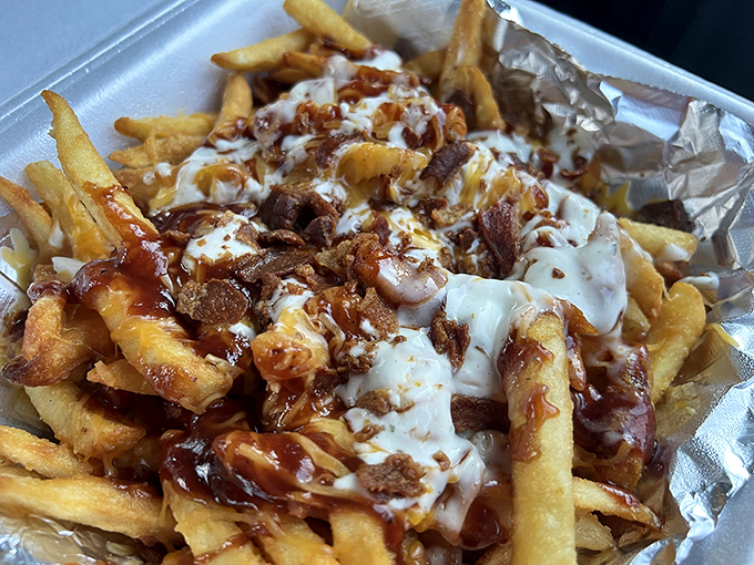 These loaded fries aren't just a side dish – they're a main event. Cheese, bacon, and sauce creating a symphony of indulgence.