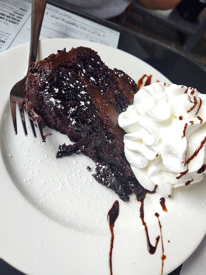 Chocolate cake so decadent it should require a permission slip, topped with whipped cream that's clearly not phoning it in.