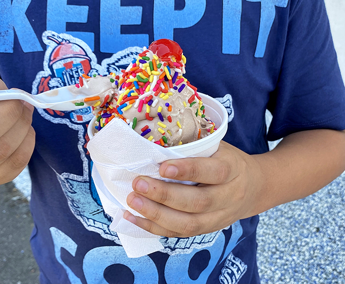 Childhood happiness in hand—sprinkles aren't just toppings, they're tiny, colorful promises that today is going to be great.