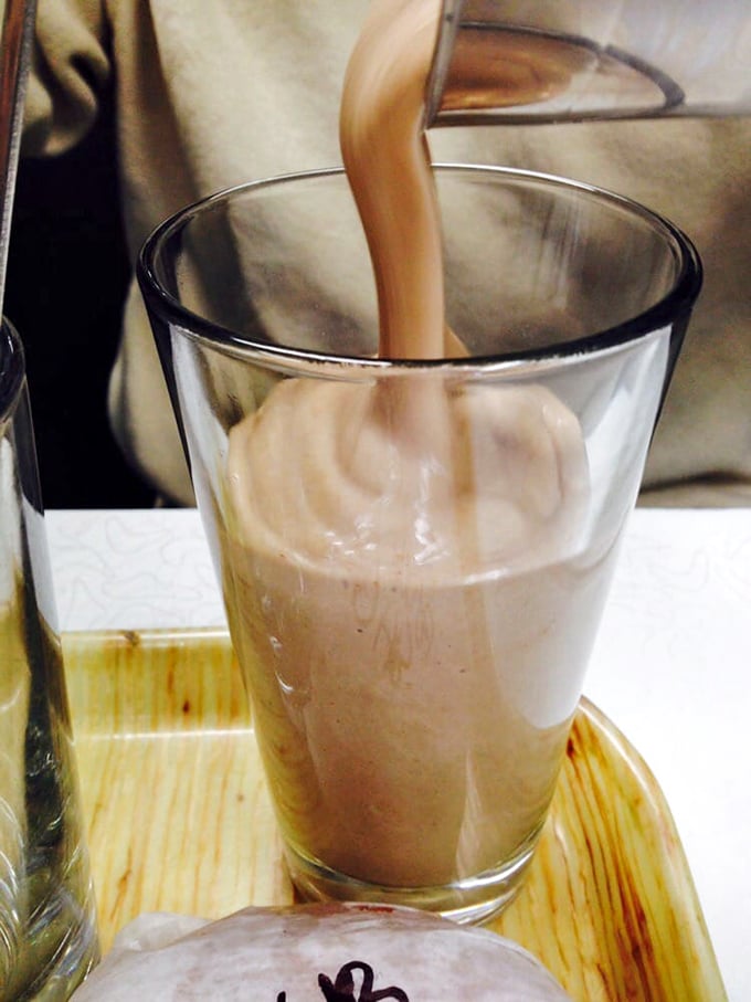 The chocolate milkshake—thick enough to require serious straw strength. This isn't a drink; it's a dessert that happens to be sippable... eventually.