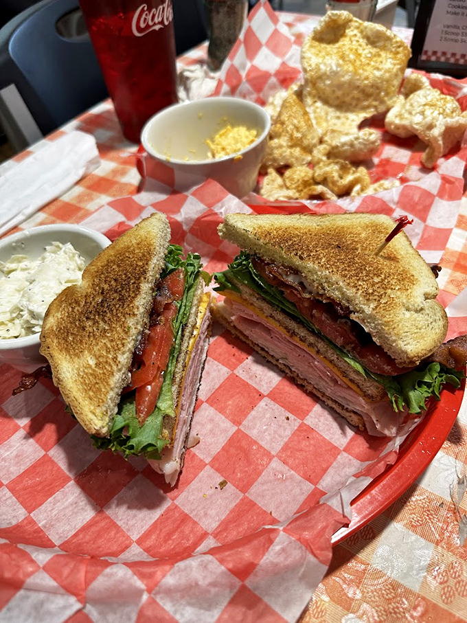 The club sandwich—architecture you can eat. Layers of meat, cheese, and veggies stacked between perfectly toasted bread, proving simplicity can be spectacular.