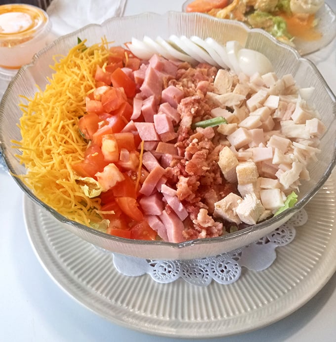 This Cobb salad isn't just arranged—it's choreographed, with each ingredient performing its role in perfect harmony on the culinary stage.