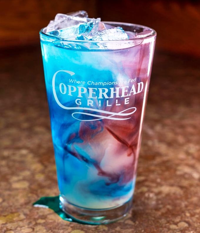 A cocktail that's having more fun than most people. Those blue and red layers aren't just pretty—they're plotting flavor revolution.