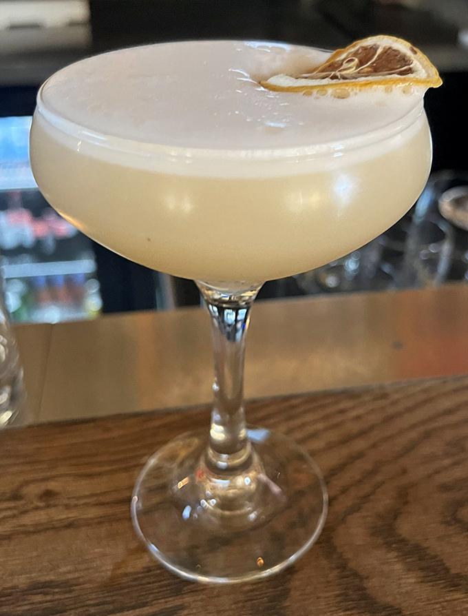 A perfectly crafted cocktail with a dried citrus garnish – because sometimes you need something elegant to wash down all that magnificent pizza.