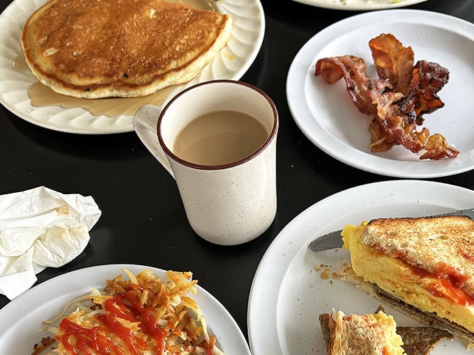 A proper diner spread with coffee in that iconic mug—the kind that somehow makes the coffee taste better than any fancy porcelain ever could.