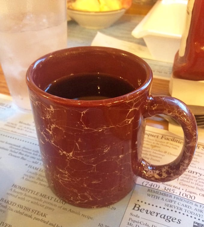 That classic diner coffee mug – sturdy, no-nonsense, and filled with the liquid courage needed to tackle the buffet for round two.