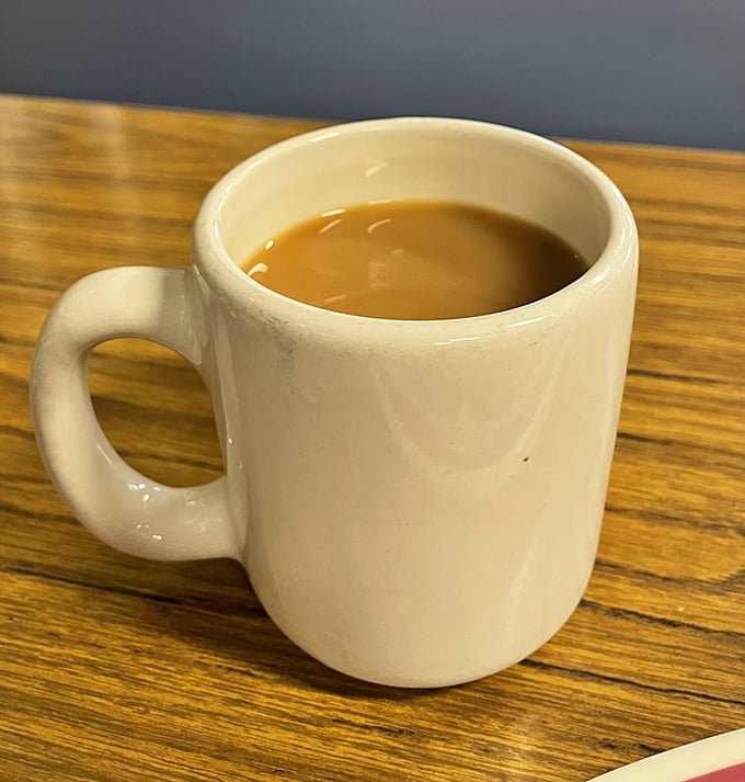 The humble diner coffee mug—unassuming vessel of morning salvation. No fancy latte art needed when the coffee's this honest.
