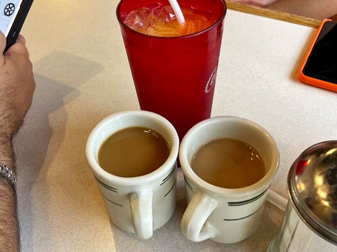The unsung hero of breakfast—honest, no-nonsense coffee in classic diner mugs, ready to transform morning zombies into functioning humans.