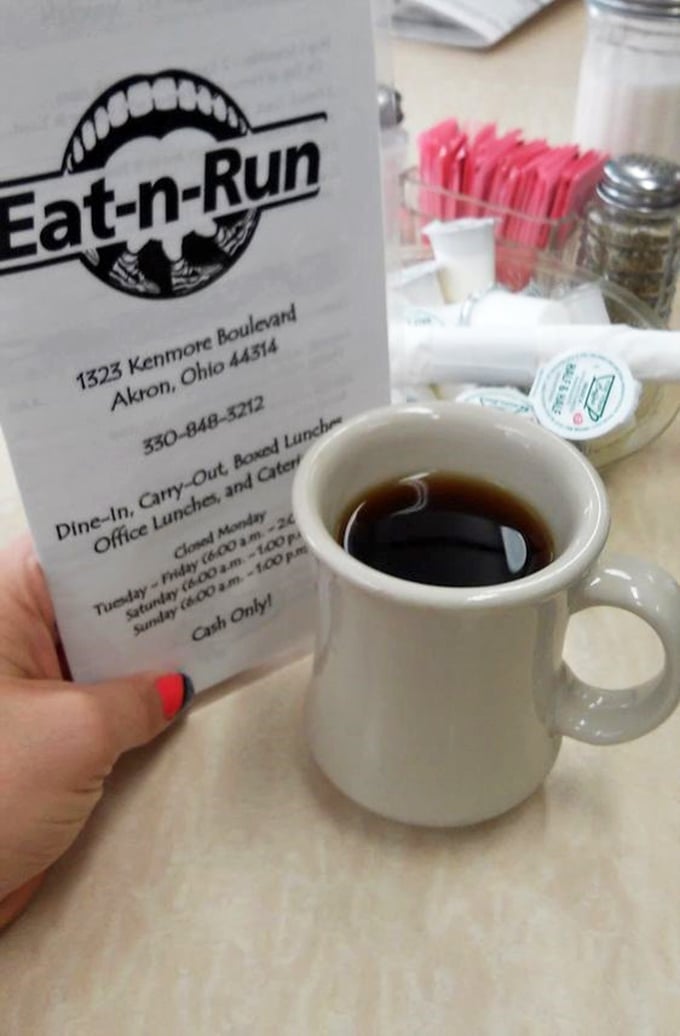 That classic diner mug doesn't just hold coffee—it holds the promise of a day that might actually turn out okay. Note the pink sweetener packets standing by.