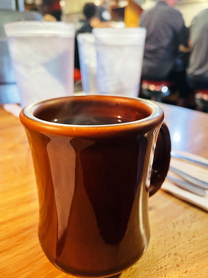 The coffee comes in these sturdy brown mugs that say, "We're not here for Instagram—we're here to wake you up properly." 