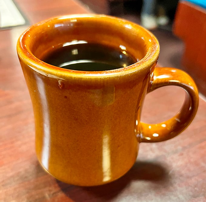 The humble coffee mug—keeper of morning salvation, warm to the touch, bottomless by local diner law. 