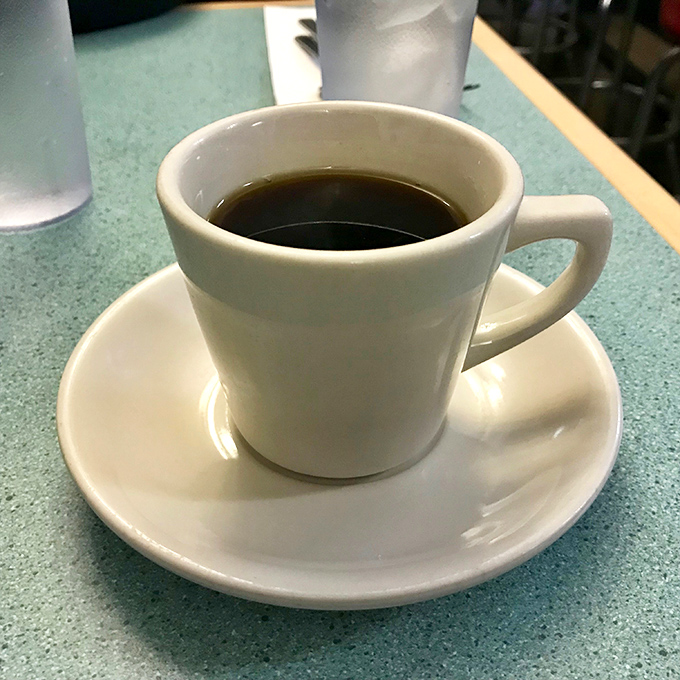 The unsung hero of every great breakfast – a simple cup of coffee that doesn't need fancy names or elaborate foam art to get the job done.