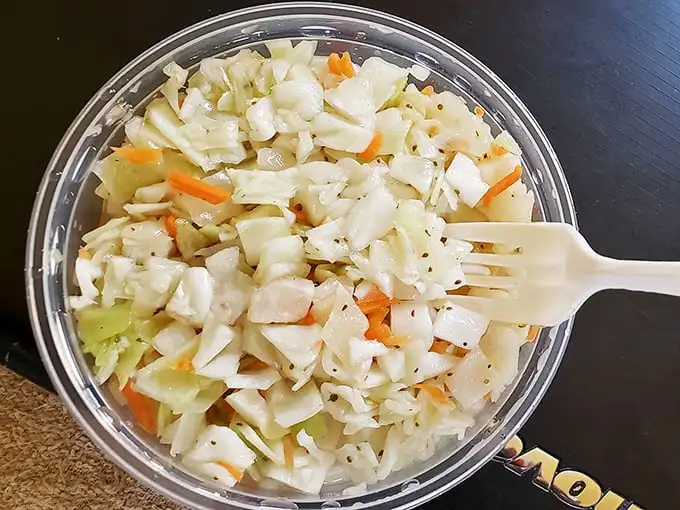 This isn't just coleslaw – it's the cool, crisp counterpoint that makes every bite of hot fried fish sing with perfect harmony.