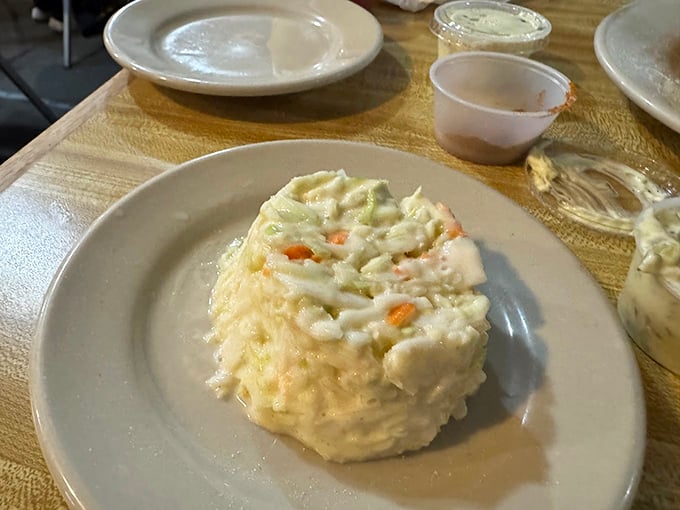 This isn't just coleslaw—it's the cool, creamy counterpoint that brings balance to the universe of fried delights on your plate.