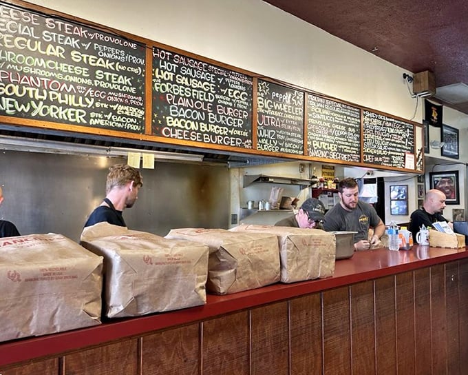 Behind the counter where sandwich magic happens. These aren't just cooks; they're artists whose canvas happens to be bread and meat.